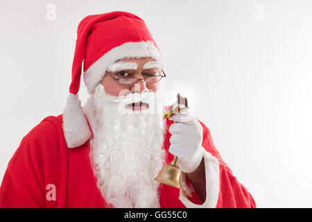 Close-up of Santa Claus eating chocolate bar over white background ...
