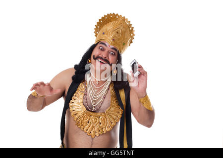 Man dressed as Raavan with a mobile phone laughing Stock Photo - Alamy