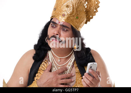 Man dressed as Raavan with a mobile phone laughing Stock Photo - Alamy