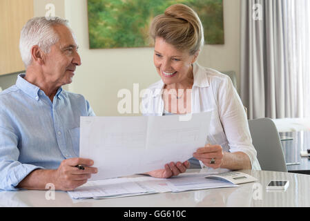 Senior couple doing paperwork Stock Photo - Alamy