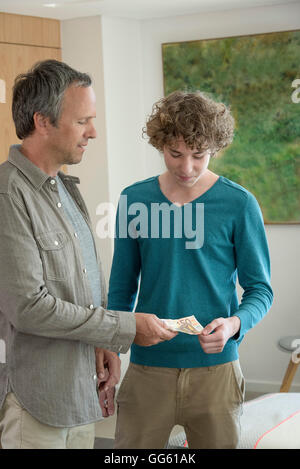 father giving money to son Stock Photo - Alamy