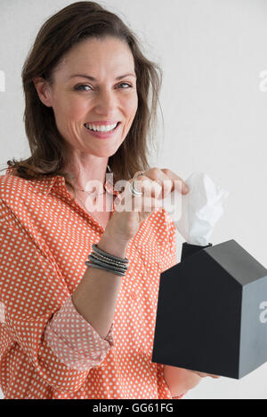 Woman pulling tissue out of box Stock Photo - Alamy