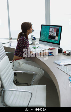 business woman working on desktop computer at modern startup office ...
