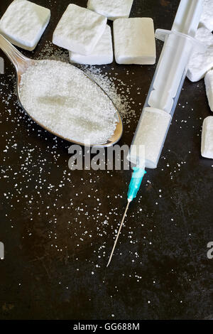 Injection with needle filled with sugar on black rustic background ...