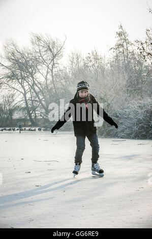Locals take advantage of conditions by ice-skating on a frozen pond at ...