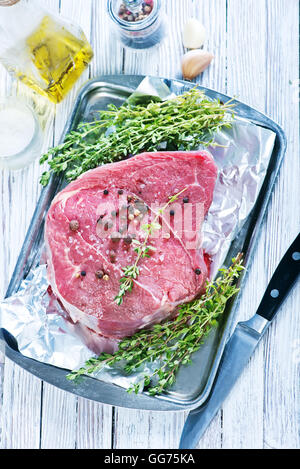 raw meat with aroma sxpice on a kitchen table Stock Photo - Alamy