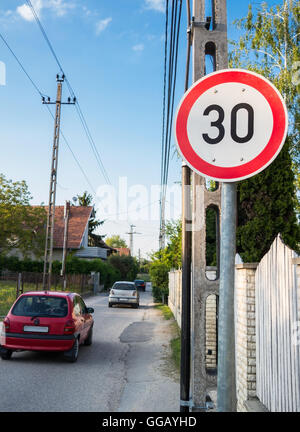 Round sign warning about speed limits, trees. the speed limit is 80 km ...