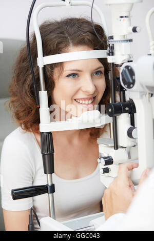 pretty young optometrist at work, examinating your eyes Stock Photo - Alamy