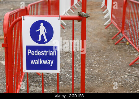 Pedestrian walkway sign and barriers on a UK construction site Stock ...