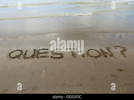 QUESTIONS written on the beach sand Stock Photo - Alamy