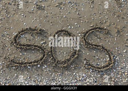 SOS big written on the beach sand Stock Photo - Alamy