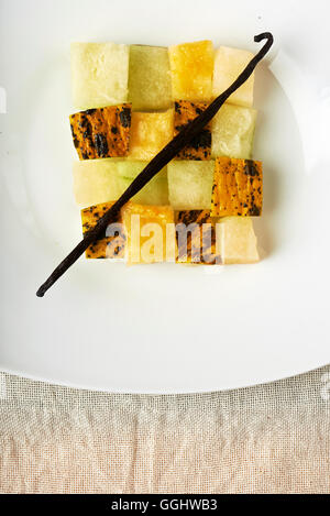Pieces of ripe melon on a brown wooden table Stock Photo - Alamy