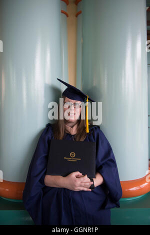 Graduate of Western Governors University poses with family member after ...