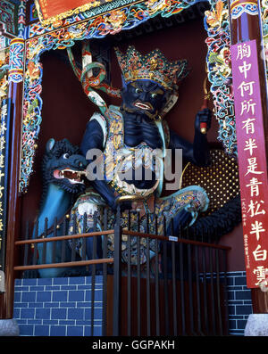 A ferocious god at the entrance to the Huatang Temple near Kunming in ...