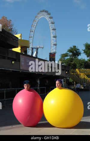 New York clown duo Acrobuffos speak to a passer-by while performing ...