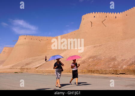 Two Uzbek women walking in street in a village near Samarkand in ...