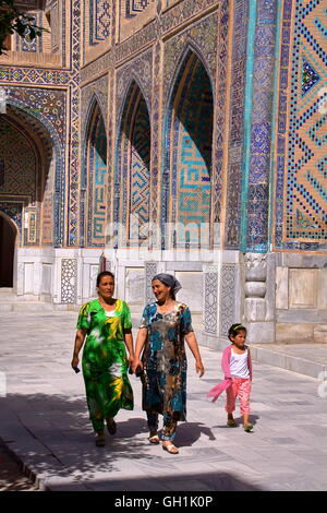 Two Uzbek women walking in street in a village near Samarkand in ...