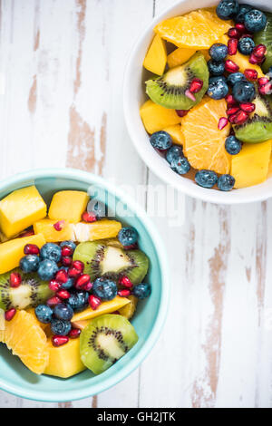assorted tropical fruit bowls with mango lychee and papaya on black ...