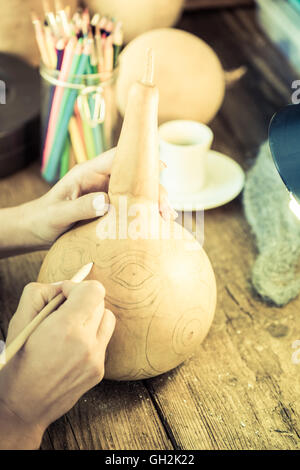 carving in calabash or gourd, creative artisan craft Stock Photo - Alamy