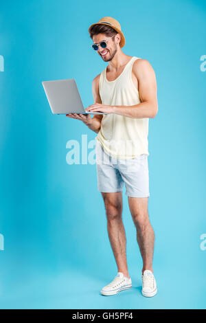 Full length photo of brunette man in striped t-shirt smiling and ...