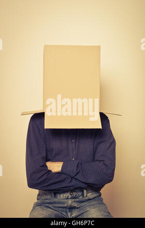 man with a blank box over his head, various concept: thinking, shy ...