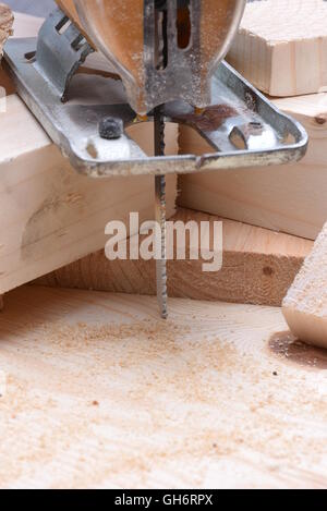 Electric jigsaw with wooden bricks closeup Stock Photo - Alamy