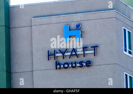 Hyatt House hotel sign with logo in landscaped parking area on a sunny ...