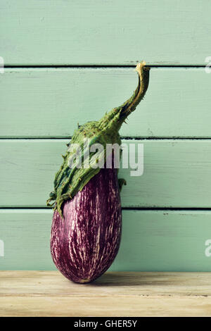 Raw eggplant on wooden table. Close up. Cropped image Stock Photo - Alamy