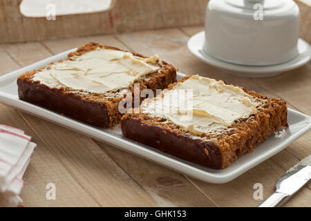 Traditional Dutch cake Ontbijtkoek with traditional butter on wooden ...