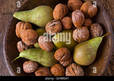 A closeup of pears on wooden bowl isolated in white background Stock ...