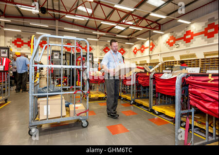 A postman at a Royal Mail sorting office Deptford, south London. UK ...