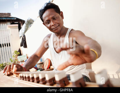 Instrument maker, Meas Mary makes a Takhe at his home in Boeng Tompu ...
