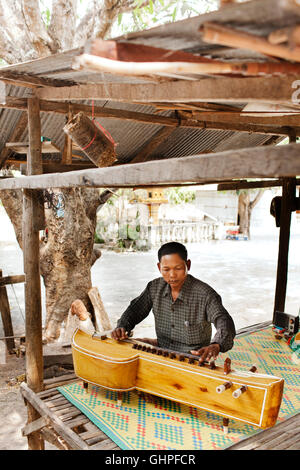 A music teacher plays a musical instrument on the background of a ...