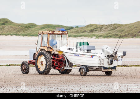 Tractor pulling boat, on trailer, onto beach, Abersoch, Gwynedd, North ...