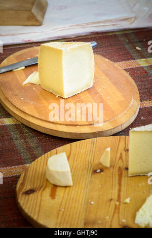 Parmesan is on the table for sale on the market. Parmigiano-Reggiano is ...