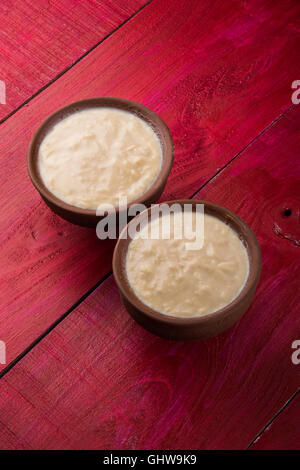 Indian sweet mishti doi bengali mithai in earthen pot on white ...