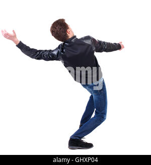 Balancing young man or dodge falling man. Rear view people collection ...