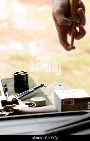 Man shooting black powder pistol at outdoor range Stock Photo - Alamy