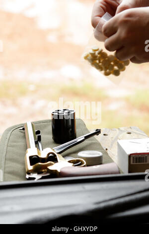 A man loading an antique black powder muzzle loading shotgun on a game ...