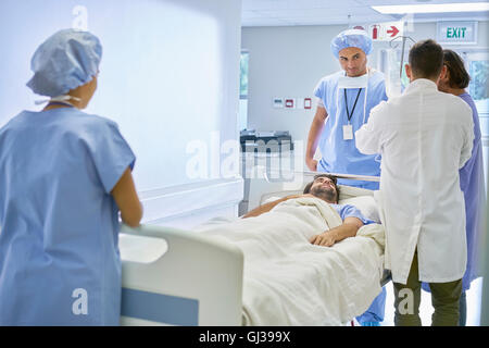 Doctors surrounding patient in hospital bed Stock Photo - Alamy