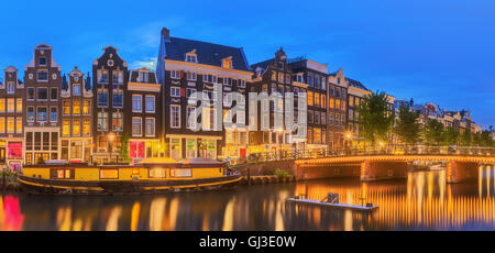 Amstel river, canals and night view of beautiful Amsterdam city ...