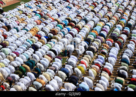 Muslim prayer. A group of Muslim are praying. They wear-ed different ...