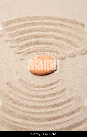 Symmetric lines in the sand with flat round sand stone Stock Photo - Alamy