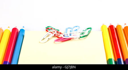 set of colored pencils and paper clips on a white background Stock ...