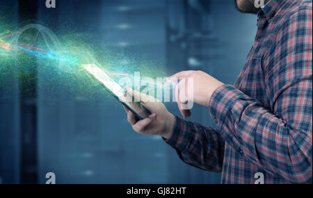 Hipster guy with tablet device . Mixed media Stock Photo - Alamy
