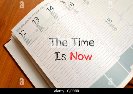 The time is now text concept write on notebook Stock Photo - Alamy