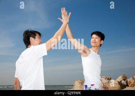 Seaside Casual Young man clapping Stock Photo - Alamy