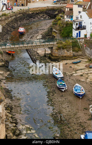 Fishing boats stranded in Staithes Harbour, North Yorkshire, at low ...