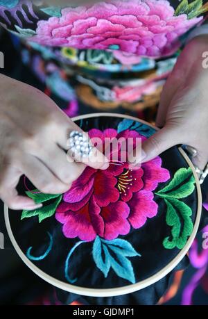 Dayao, China's Yunnan Province. 14th Aug, 2016. Luo Jun weaves an ...