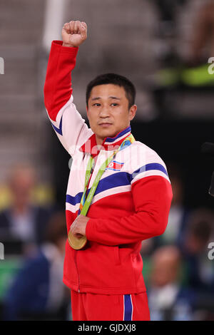 Gold Medalist Ri Se Gwang of North Korea salutes to his national anthem ...